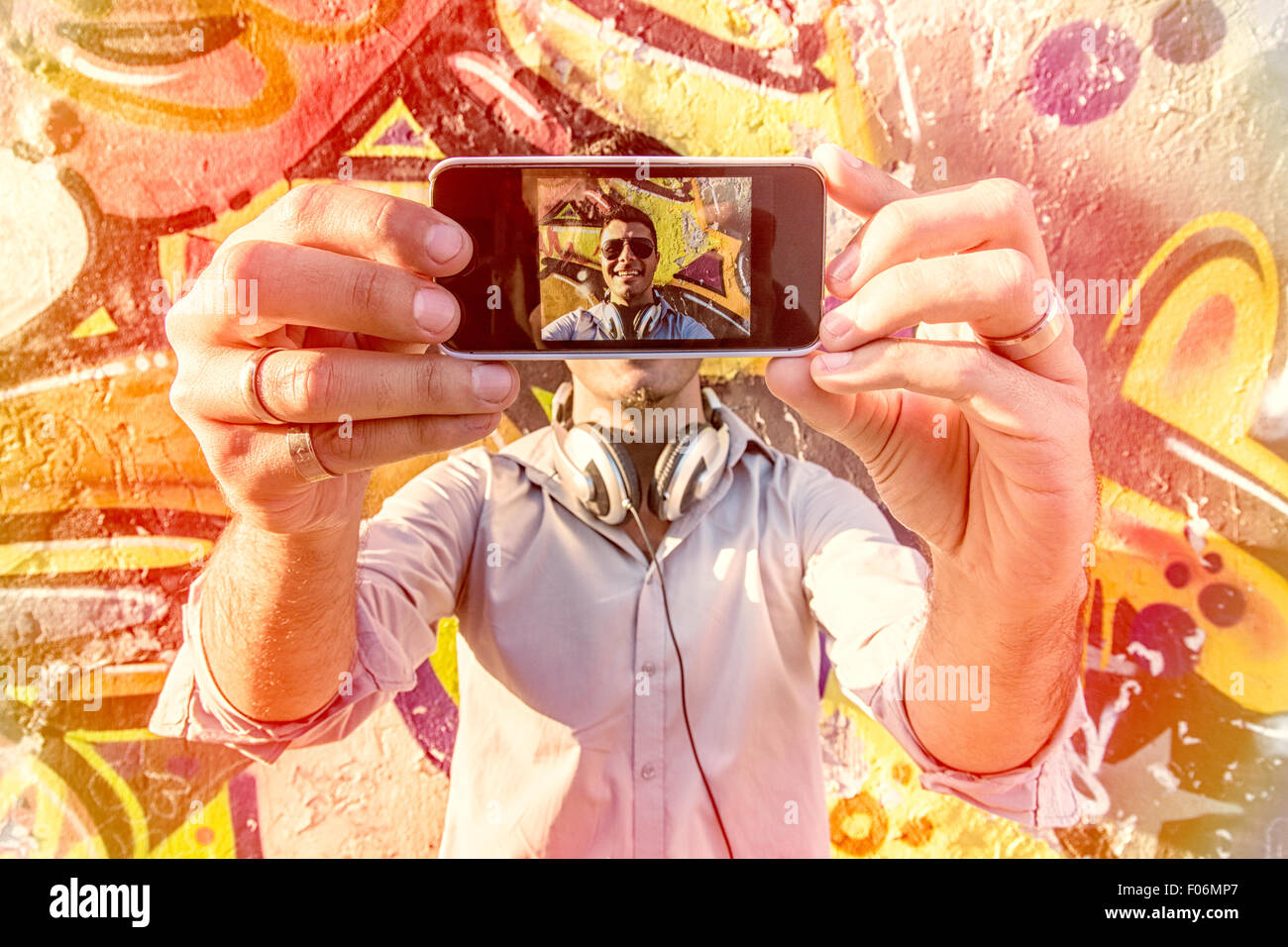 Man with smile on his face making the selfie with his cell phone ...