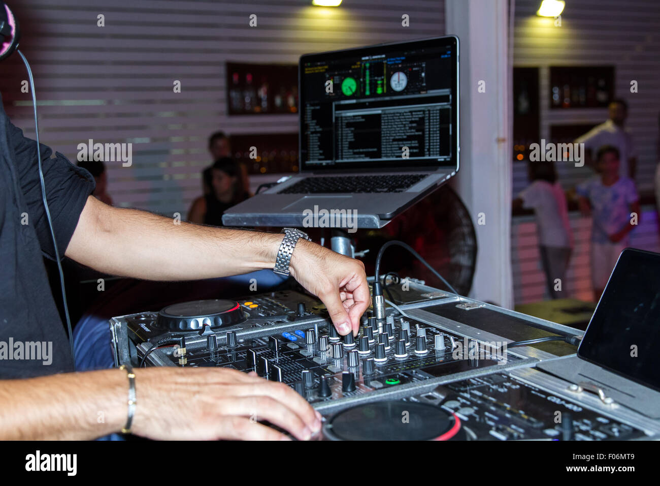 Dj hands on equipment deck and mixer with vinyl record at party Stock ...
