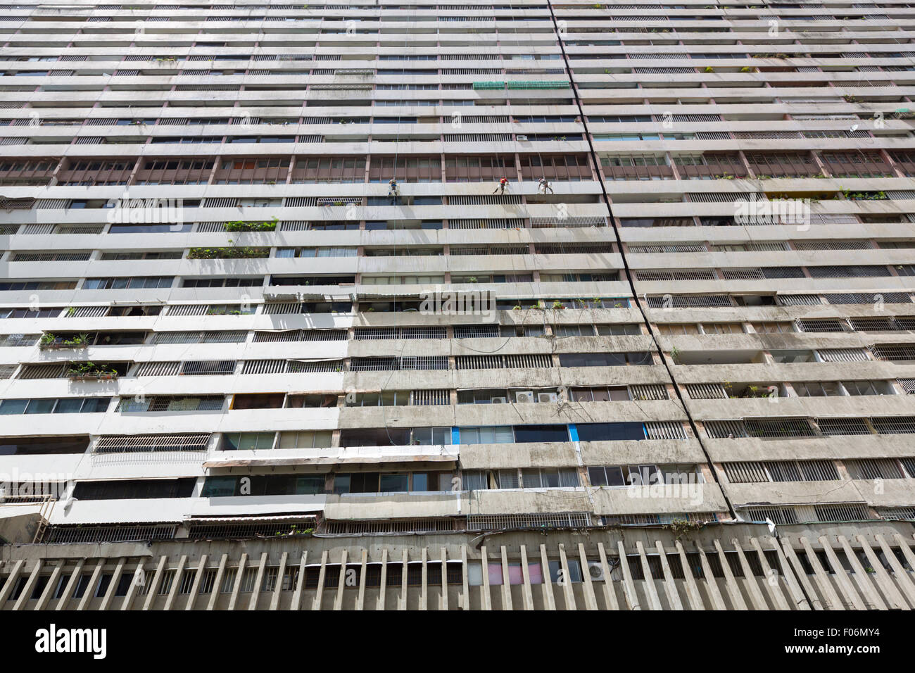 Old massive residential building in downtown with painters at work ...
