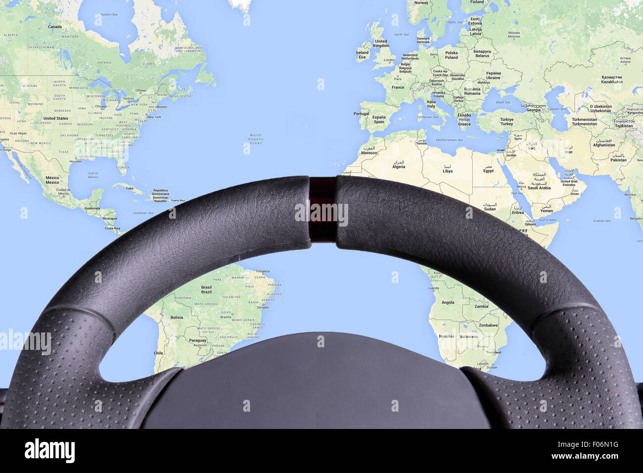 steering wheel whit a world map at background Stock Photo - Alamy