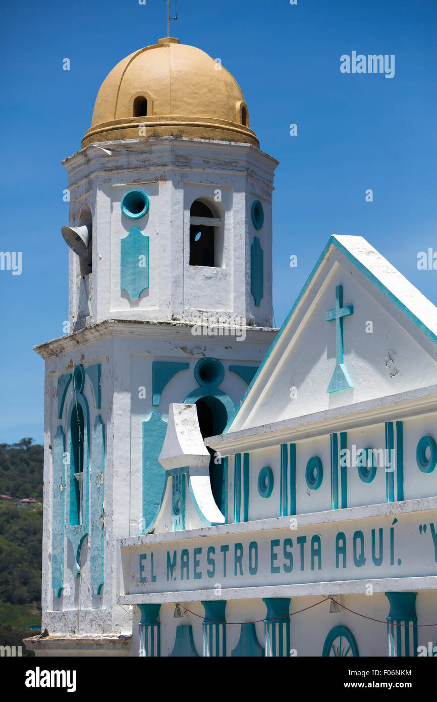 Little small blue and white small colonial church against a clear blue ...