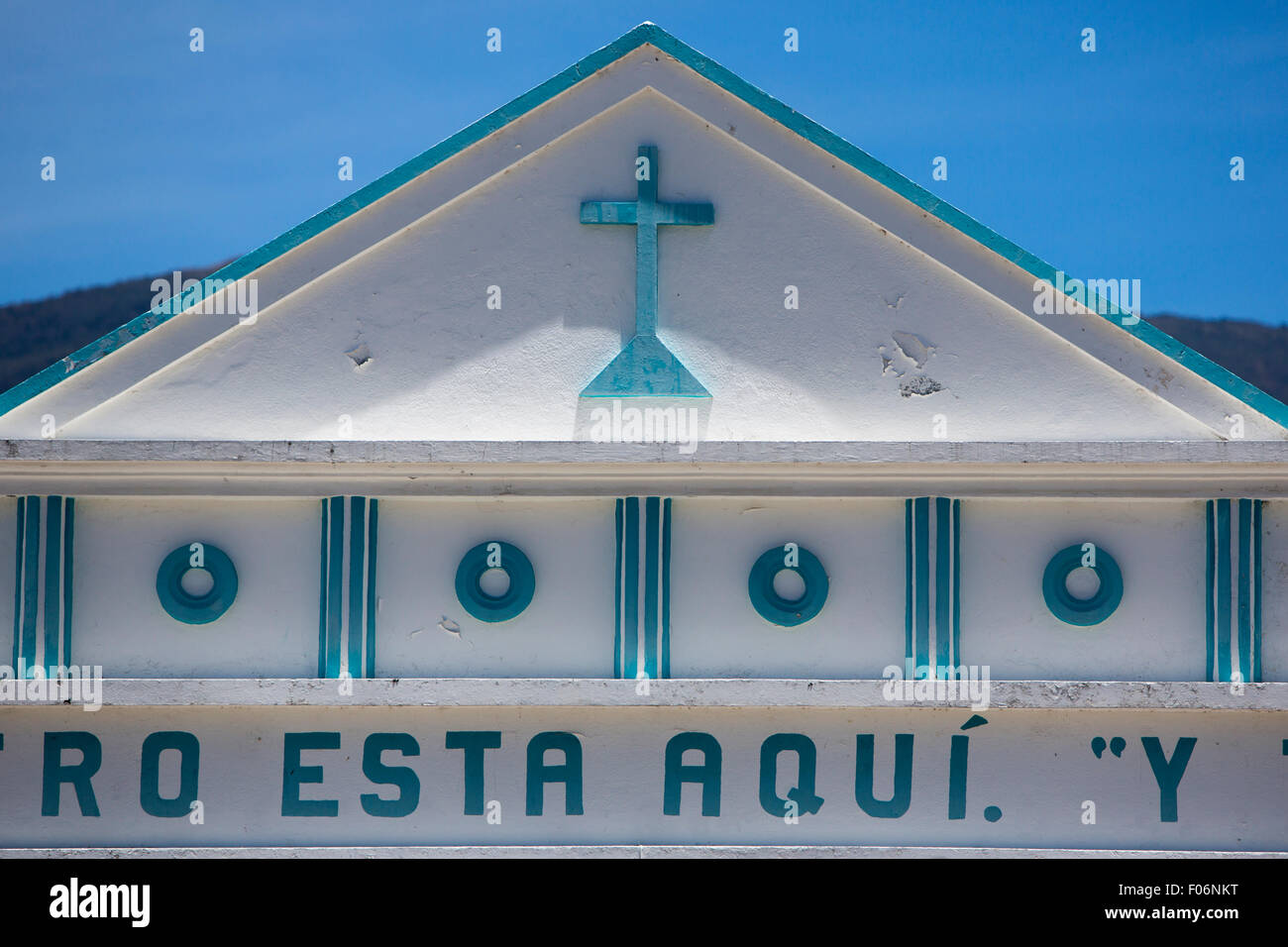 Little small blue and white small colonial church against a clear blue ...