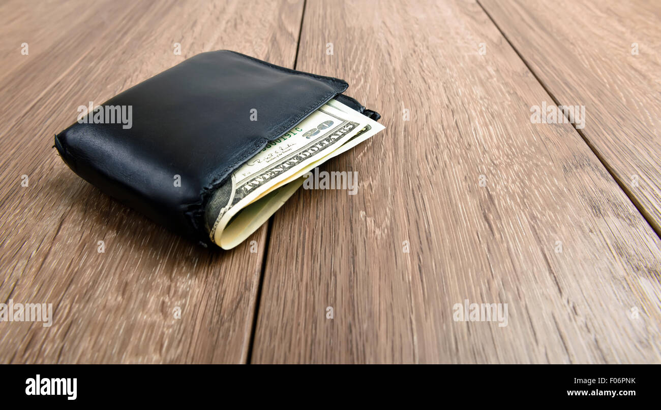 Old wallet with dollar banknotes on wooden background Stock Photo - Alamy
