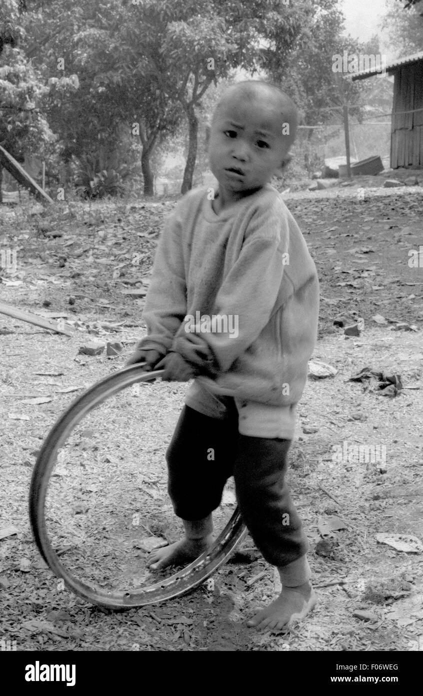 kid playing with wheel myanmar brian mcguire Stock Photo - Alamy