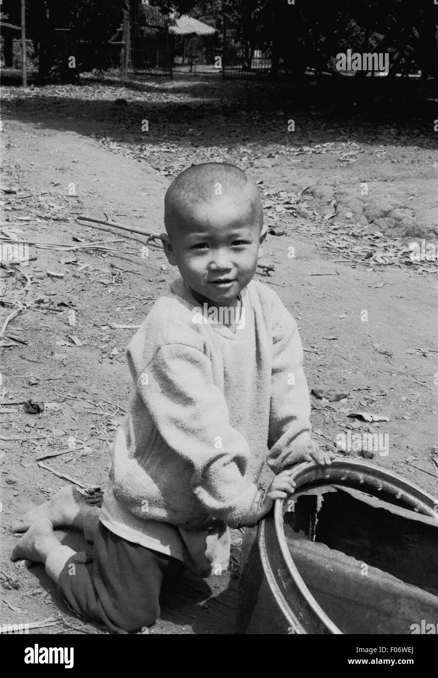 kid playing with wheel myanmar brian mcguire Stock Photo - Alamy