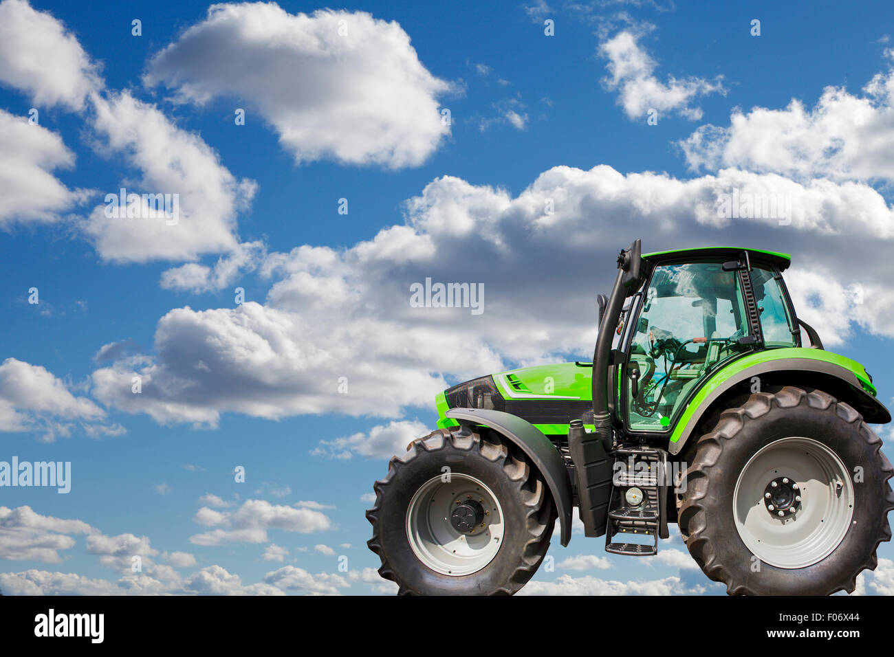 farming tractor against a blue sky Stock Photo - Alamy