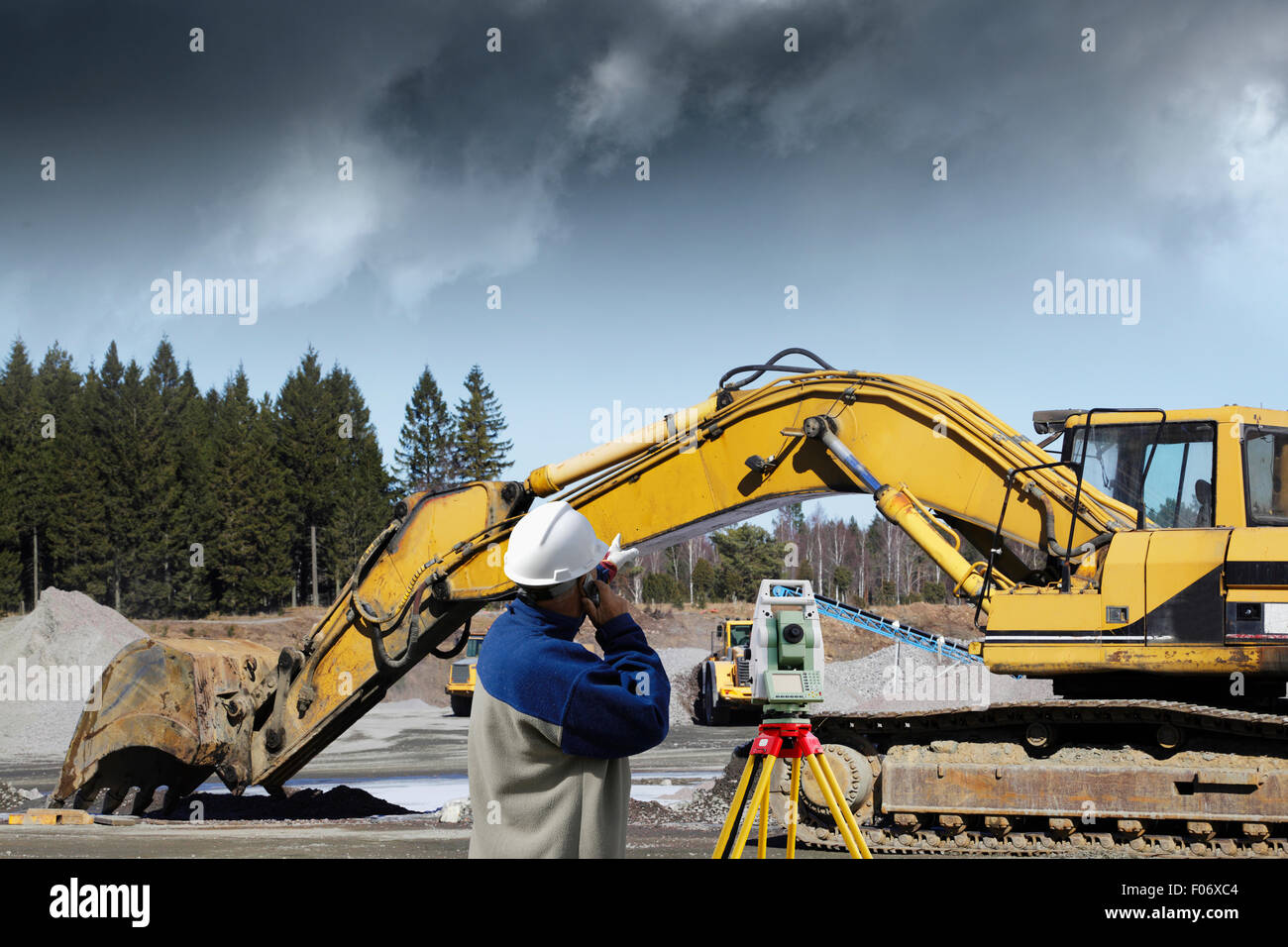 surveyor with measuring instrument and building site Stock Photo - Alamy