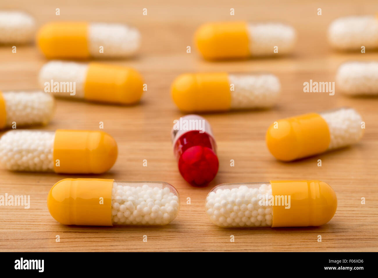 Close up medical capsules on wooden table background Stock Photo - Alamy