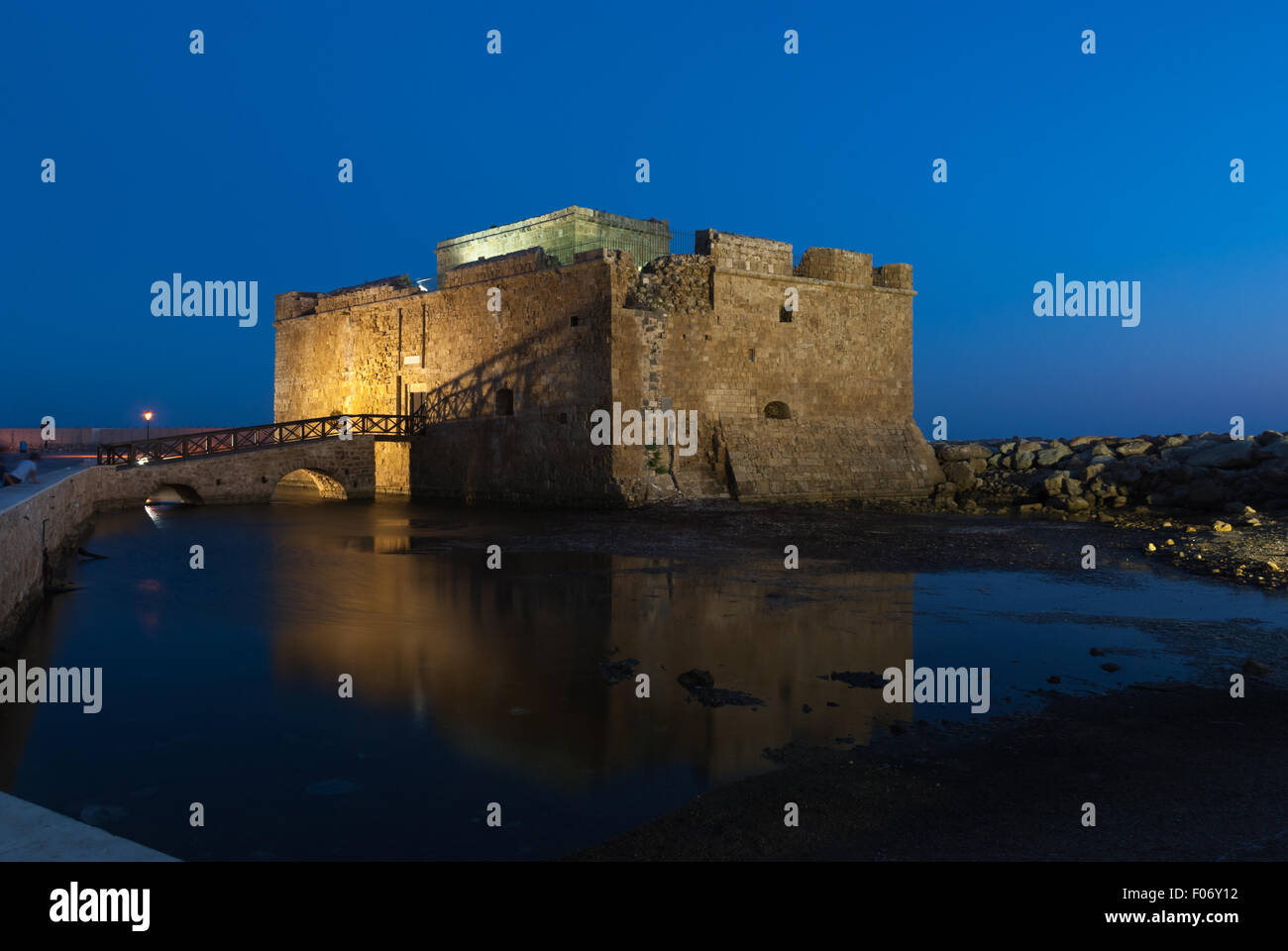 Illuminated Paphos Castle located in the city harbor at night with ...