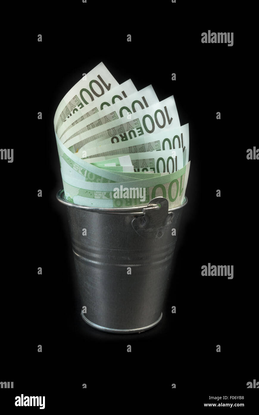Metal bucket with money isolated on black background Stock Photo - Alamy