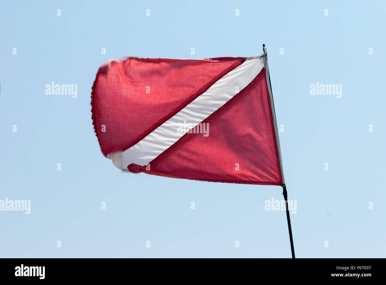 Scuba Dive Flag on the wind with blue sky as a background Stock Photo ...