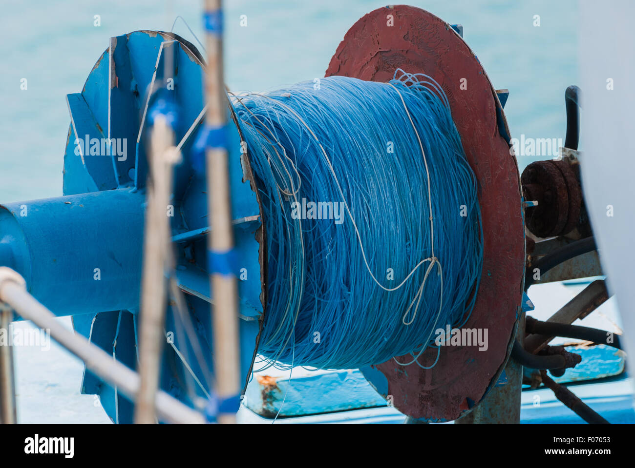 big blue metal rusted reels with long plastic fishing line closeup ...