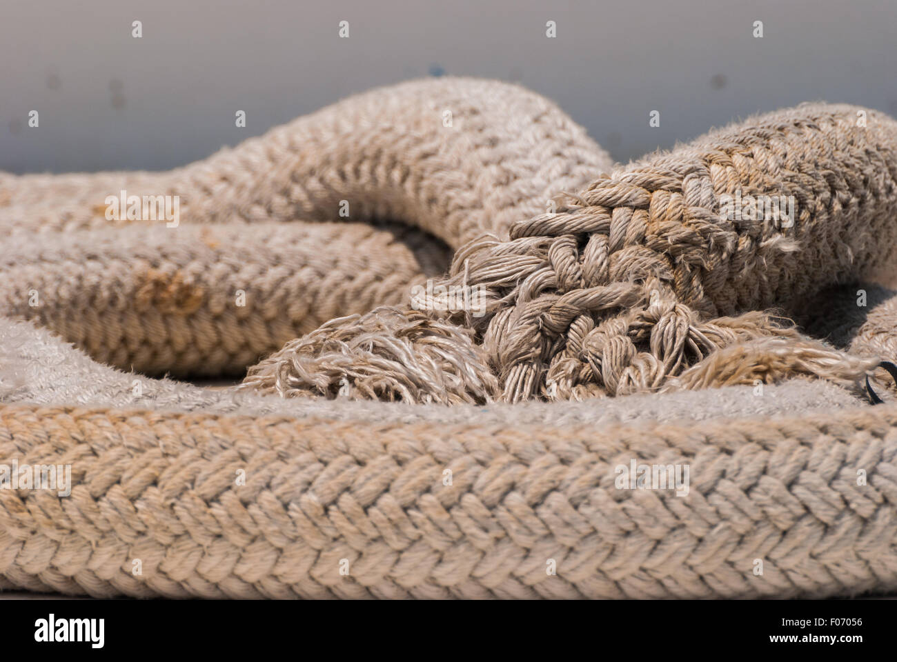 Old long nautical rope on fishing boat close-up Stock Photo - Alamy