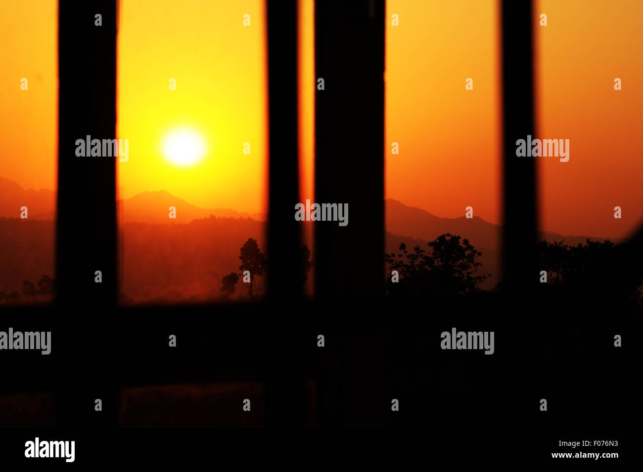 the rising sun seen from a window Stock Photo - Alamy