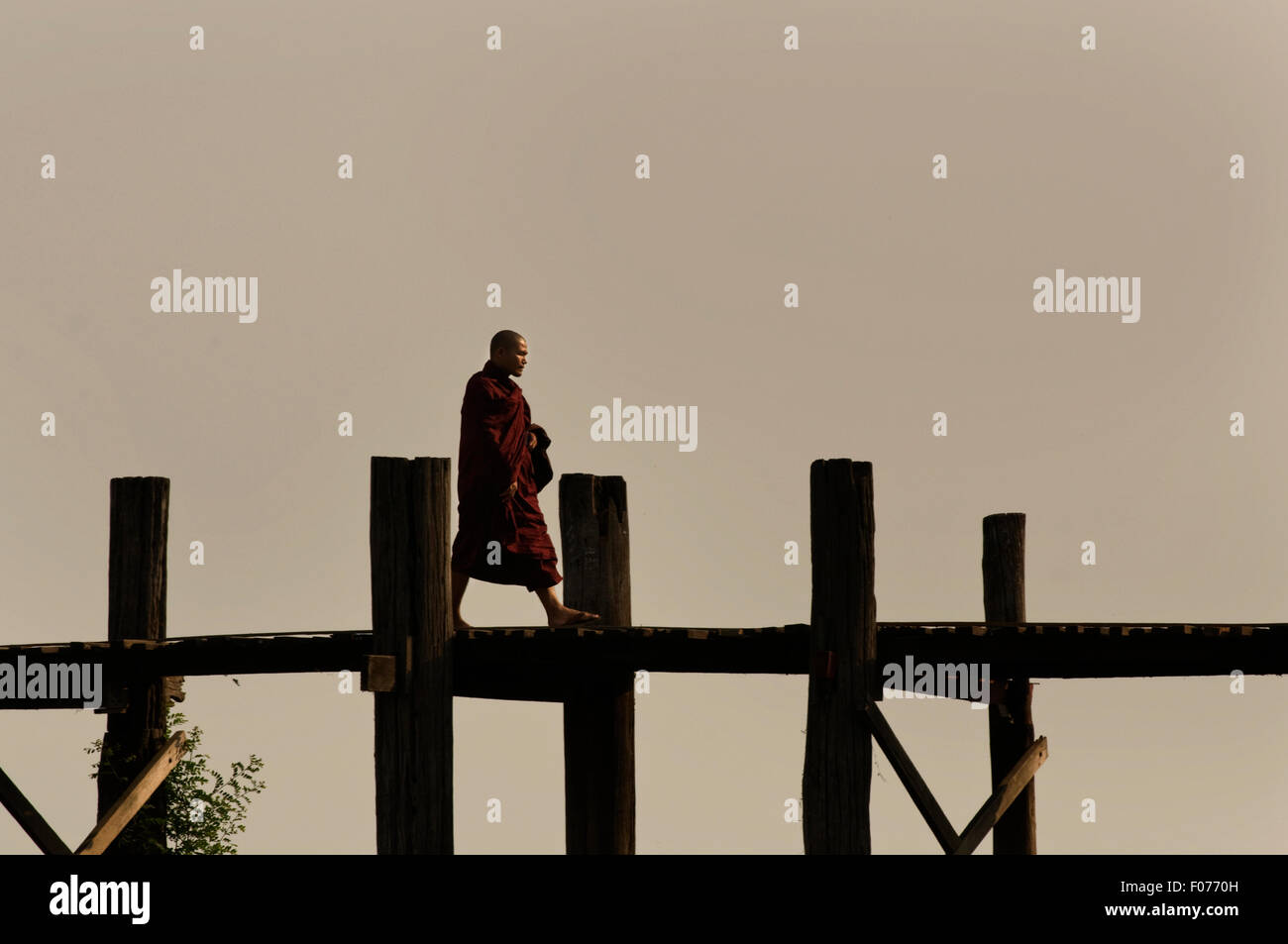 ASIA, MYANMAR (BURMA), Mandalay, Taugthaman Lake, monk crossing U Bein ...