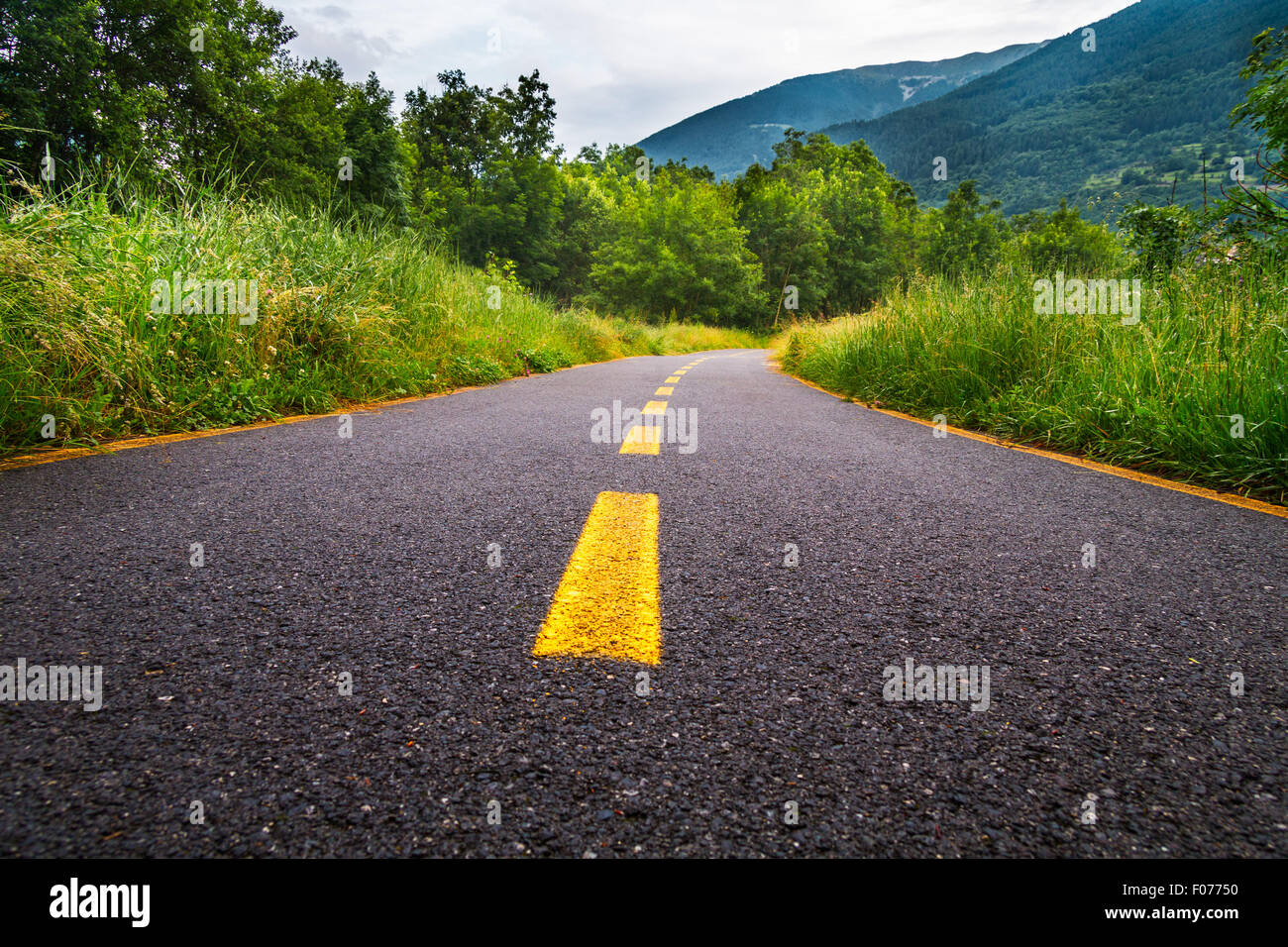 Paved cycle lane with yellow path - far destination Stock Photo - Alamy