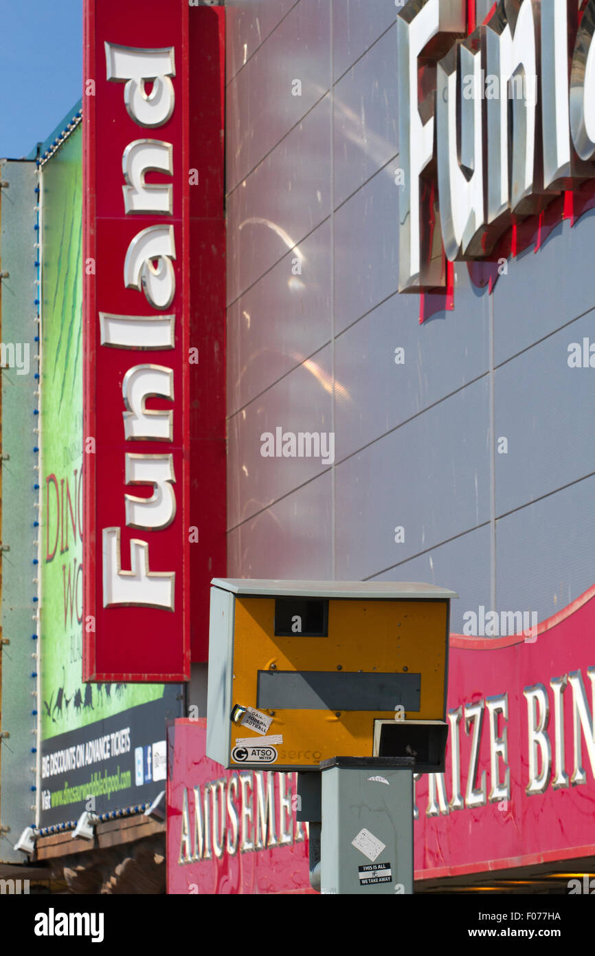 Gatso speed camera with 'Funland' sign behind Stock Photo - Alamy