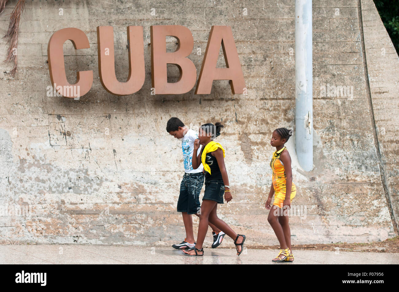 HAVANA, CUBA - JUNE 12, 2011: Group of young Cubans walk on the ...