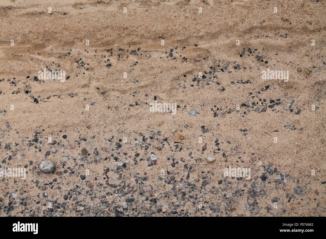 light brown color sand lay waves on the road Stock Photo - Alamy