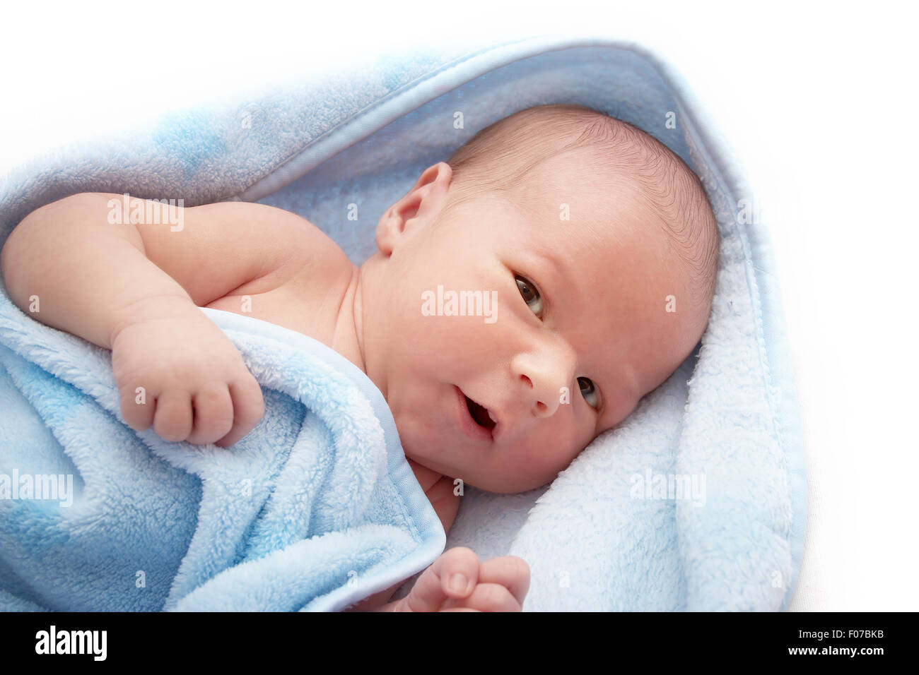 One week old baby in blanket on white background Stock Photo - Alamy