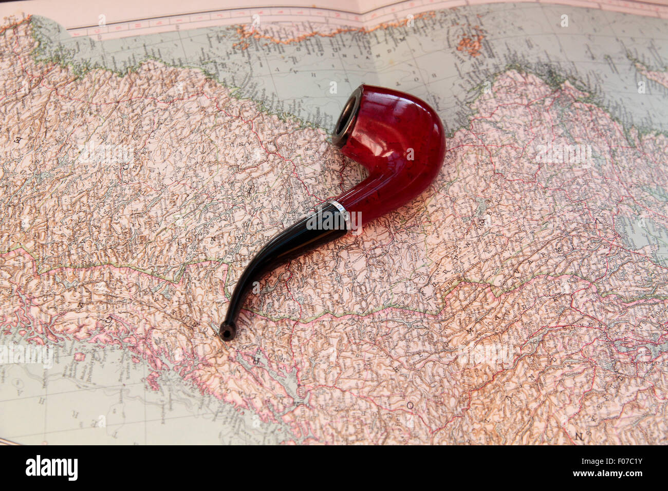 Vintage pipe on map Stock Photo - Alamy
