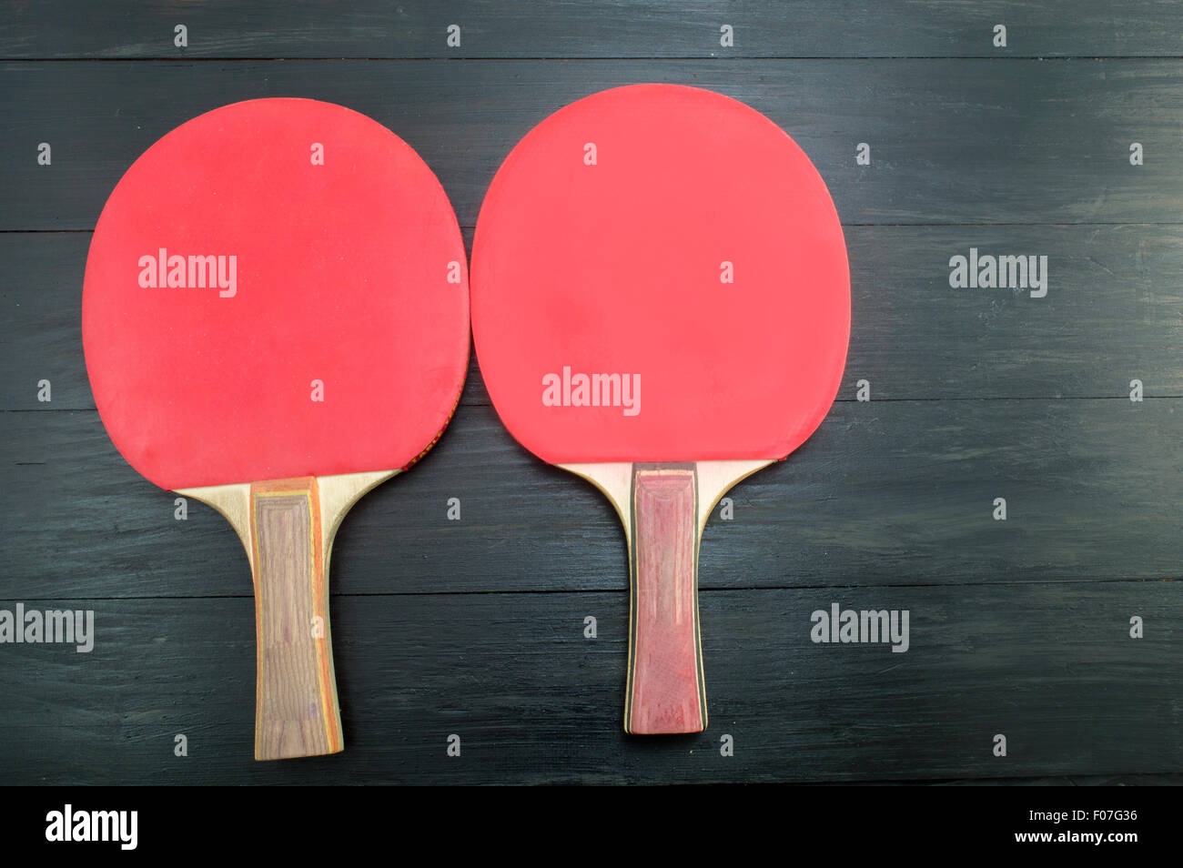 Pair of red table tennis rackets on dark background Stock Photo - Alamy