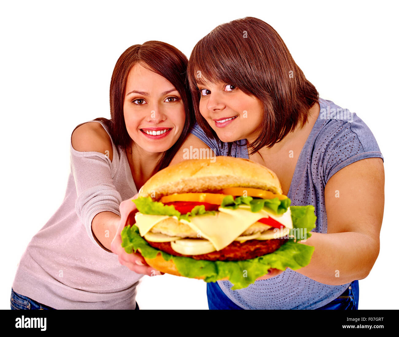 Women eating hamburger Stock Photo - Alamy
