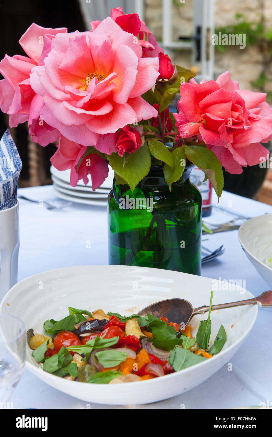 A roasted vegetable salad on the table of an outdoor picnic under a ...