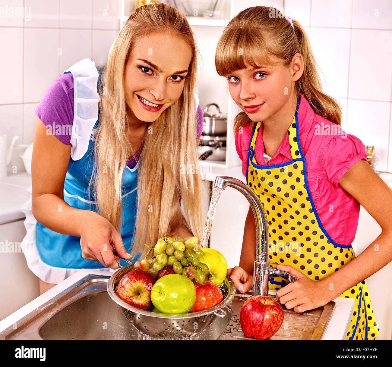 Children washing fruit at kitchen Stock Photo - Alamy