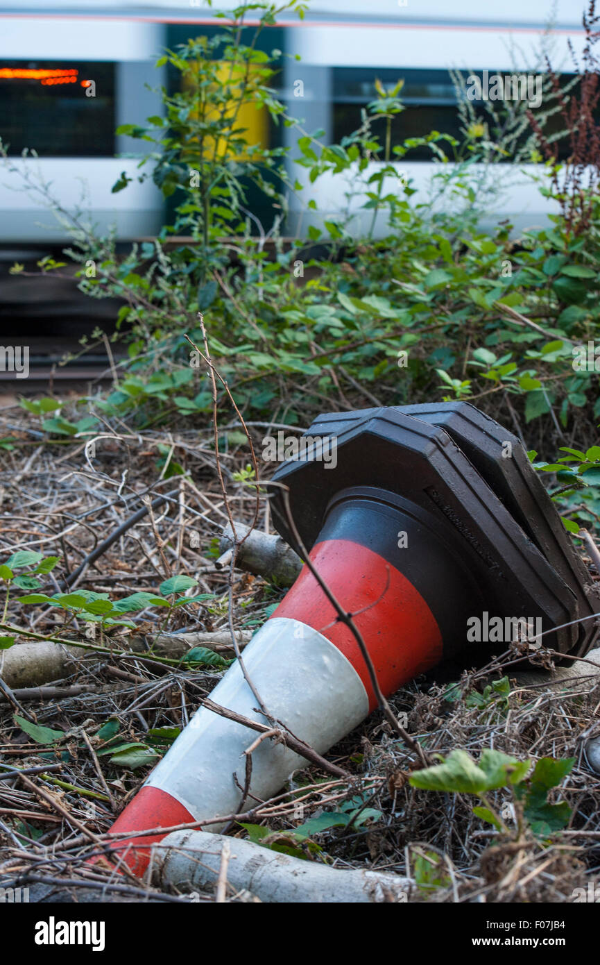 Road bollards and general rubbish on a train track with a train ...