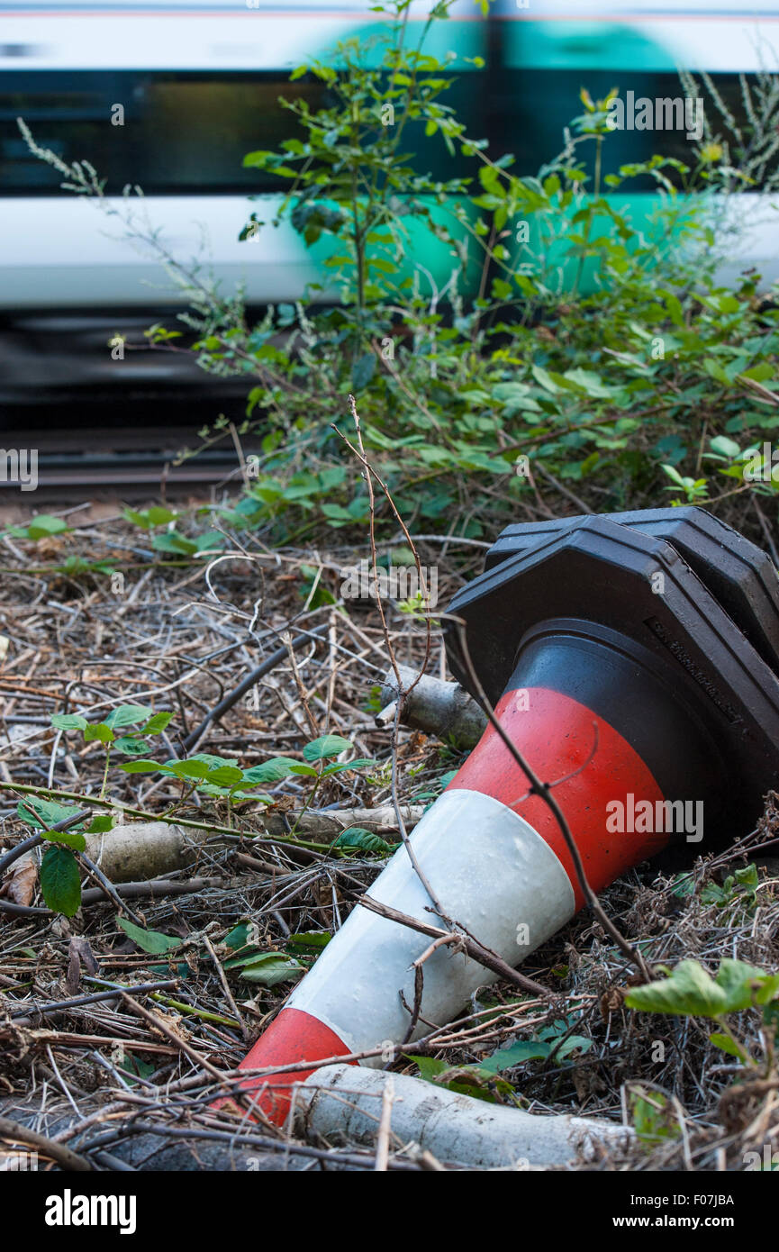Road bollards and general rubbish on a train track with a train ...