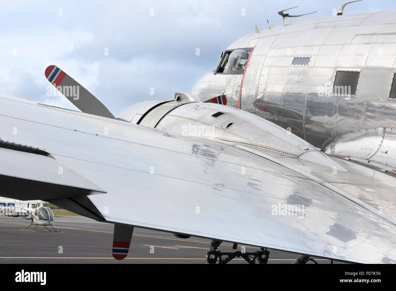 Detail of a shiny silver aircraft with the norwegian flags on its ...