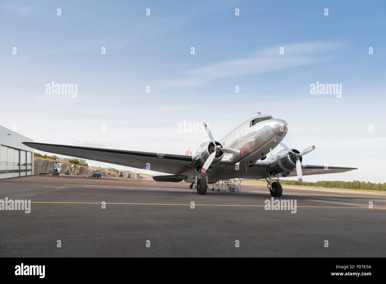 Shiny silver-coloured aircraft with two propellers in an airport Stock ...