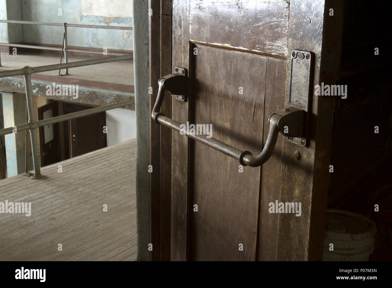Open door with metal handlebar in old school gym Stock Photo - Alamy