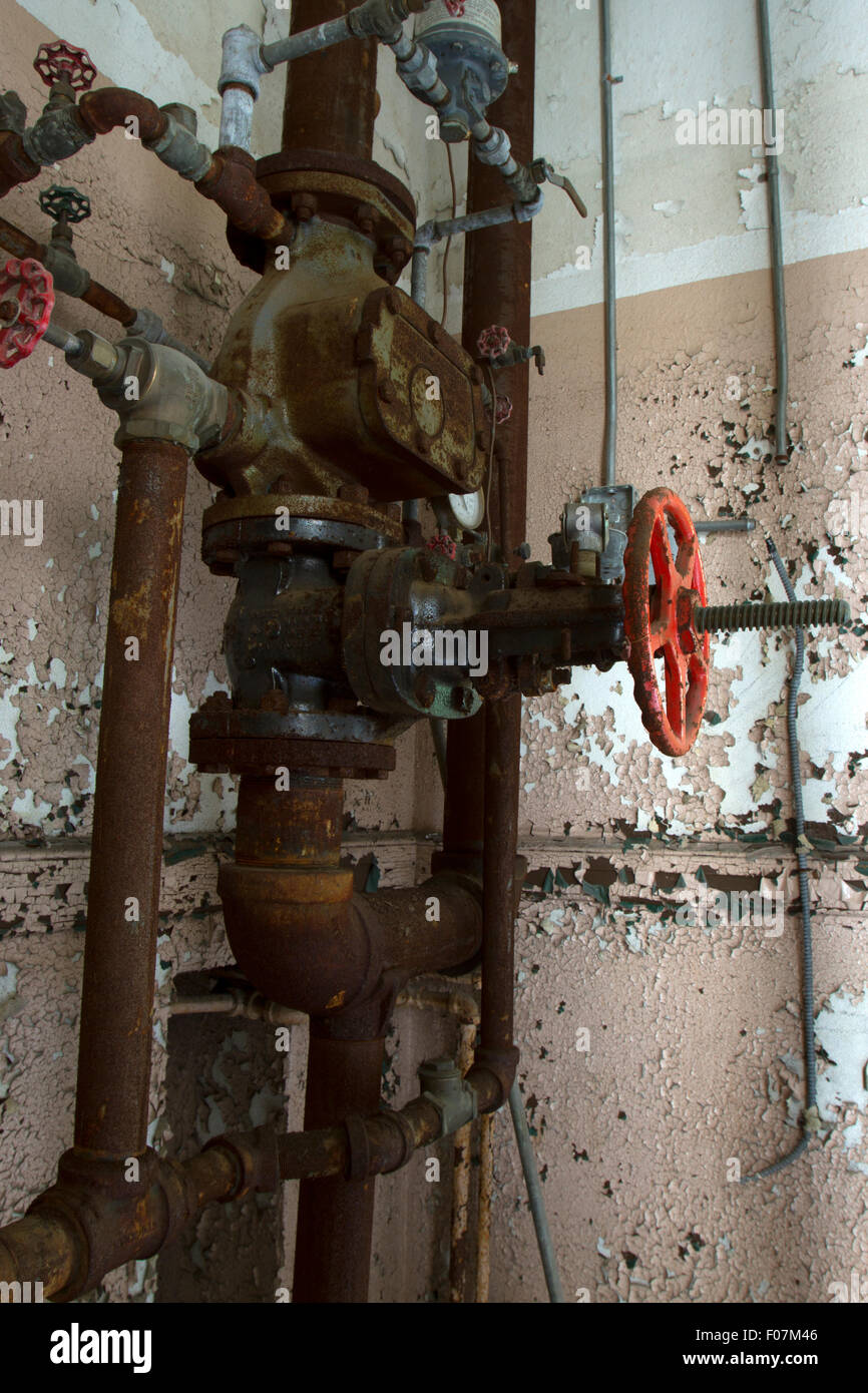 Rusty pipe main in old school building Stock Photo - Alamy