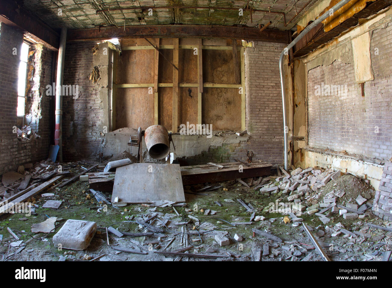 Cement mixer in room filled with debris from urban decay Stock Photo ...