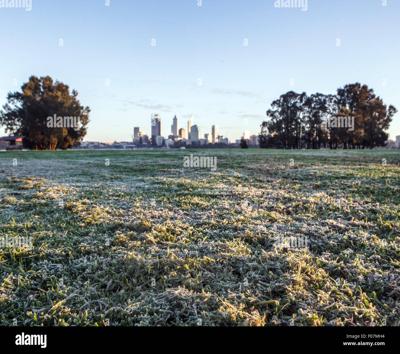 Frost and ice on the grass with Perth city in the distance. Australia ...