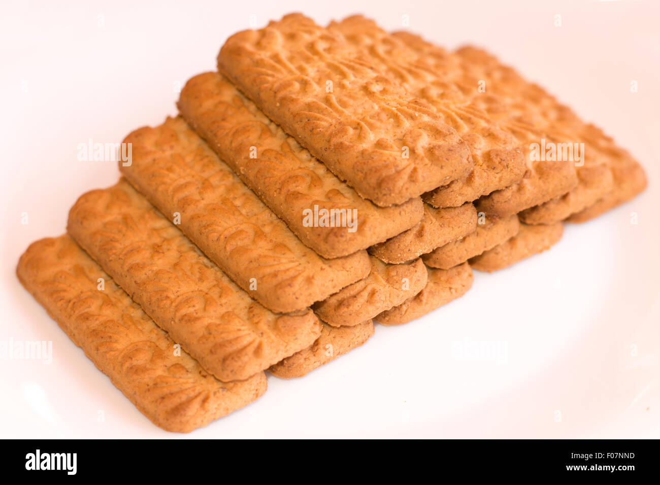 Fifteen biscuits put on a pyramid shape, isolated on white background ...