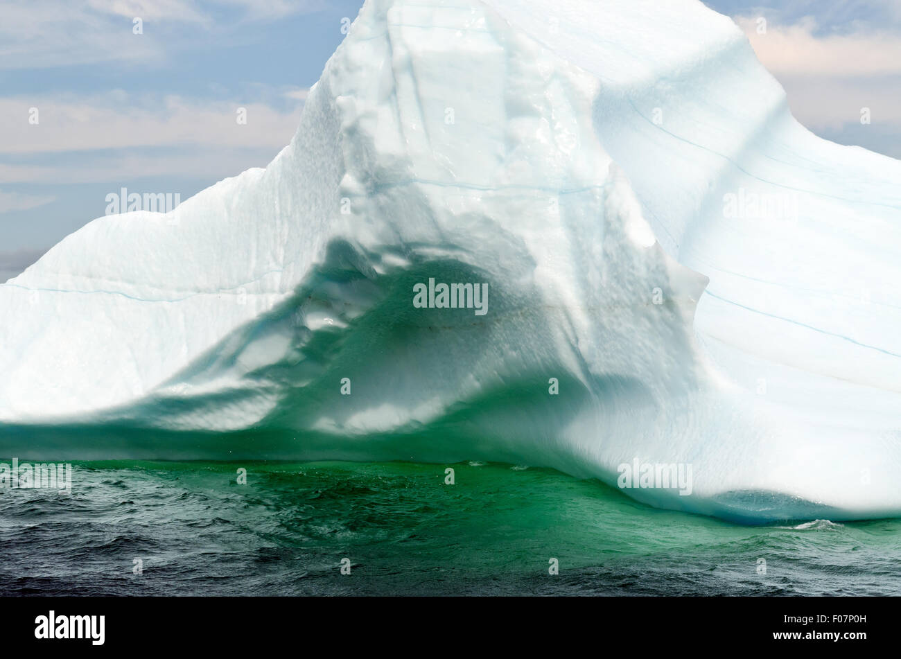 Bright white iceberg on dark water and rock background Stock Photo - Alamy