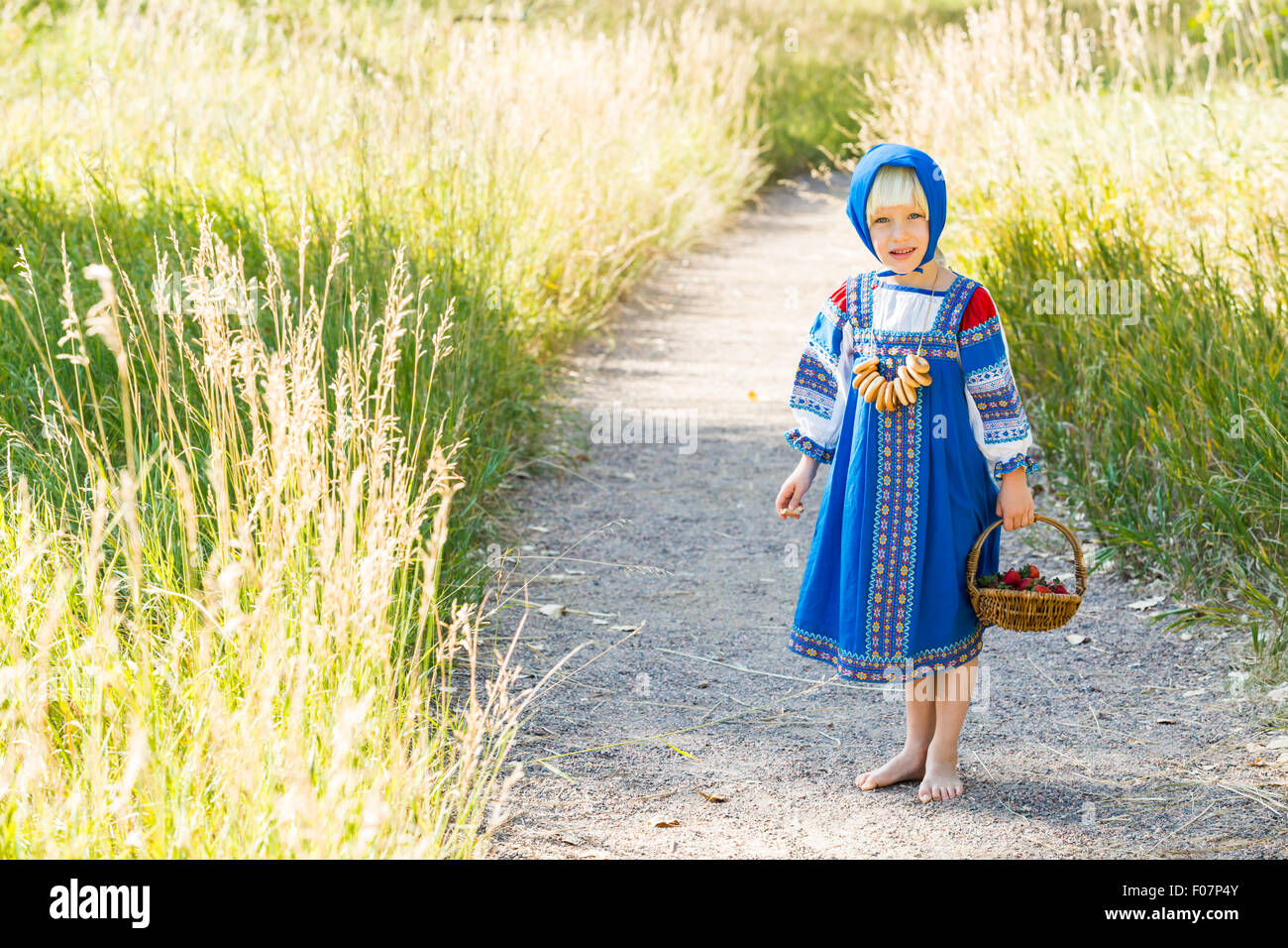 Russian children in traditional Russian costumes playing in the forest ...