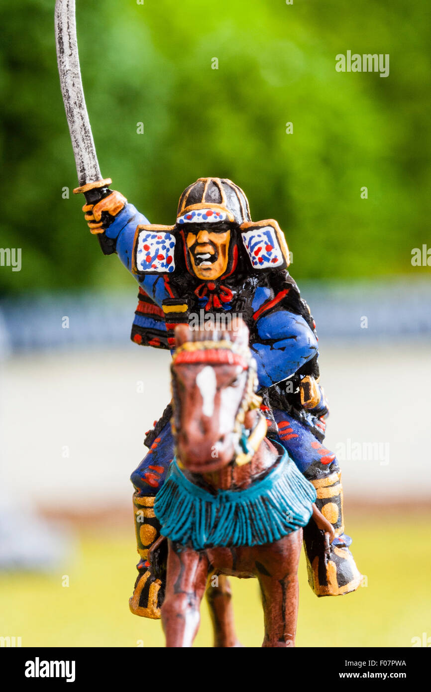 Close-up of metal painted scale model figures. Mounted Japanese samurai ...