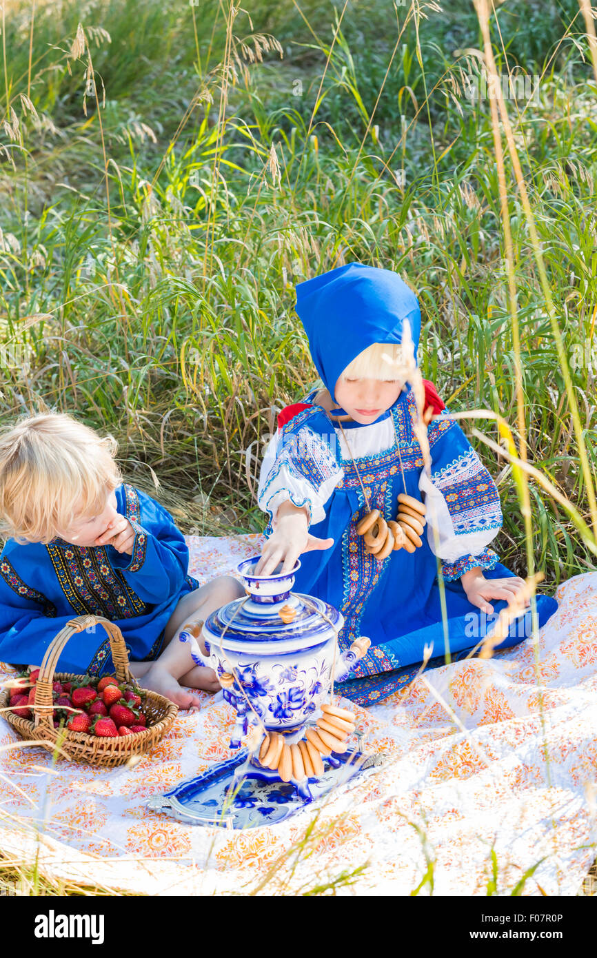 Russian children in traditional Russian costumes playing in the forest ...