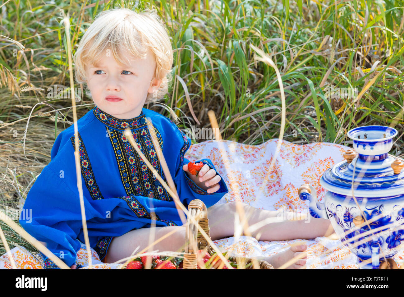 Russian children in traditional Russian costumes playing in the forest ...