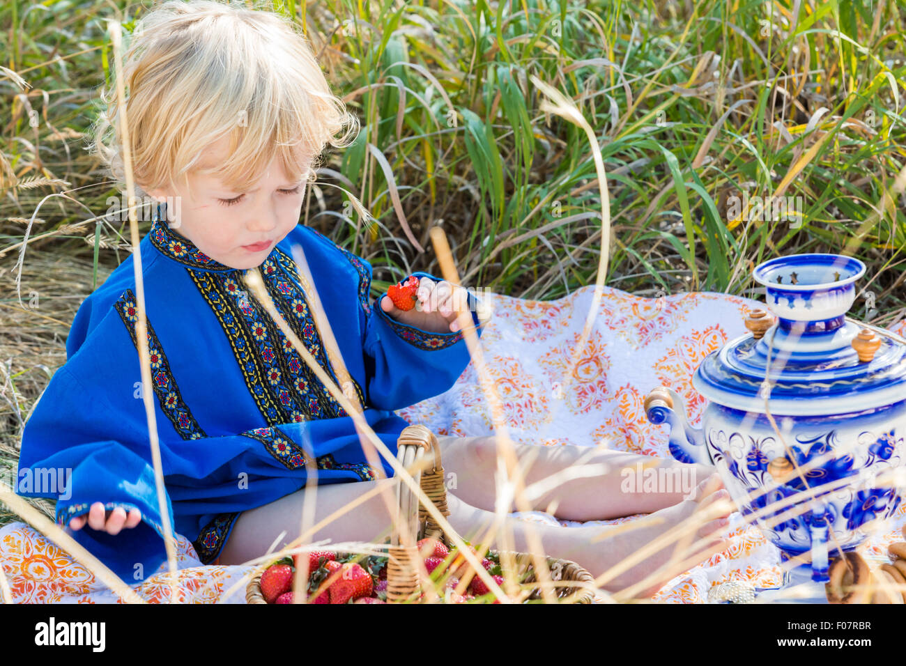 Russian children in traditional Russian costumes playing in the forest ...