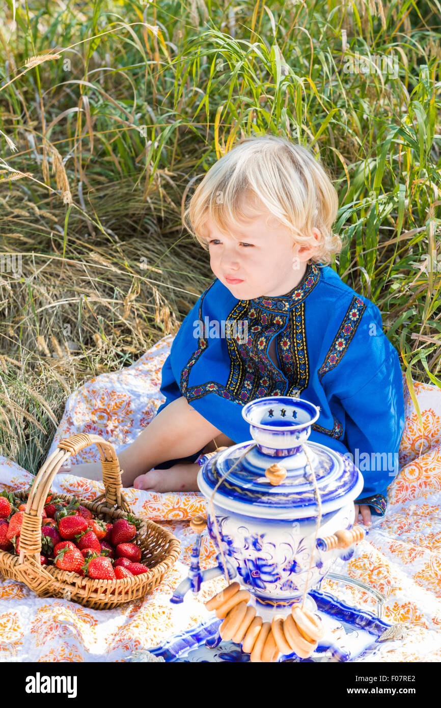Russian children in traditional Russian costumes playing in the forest ...