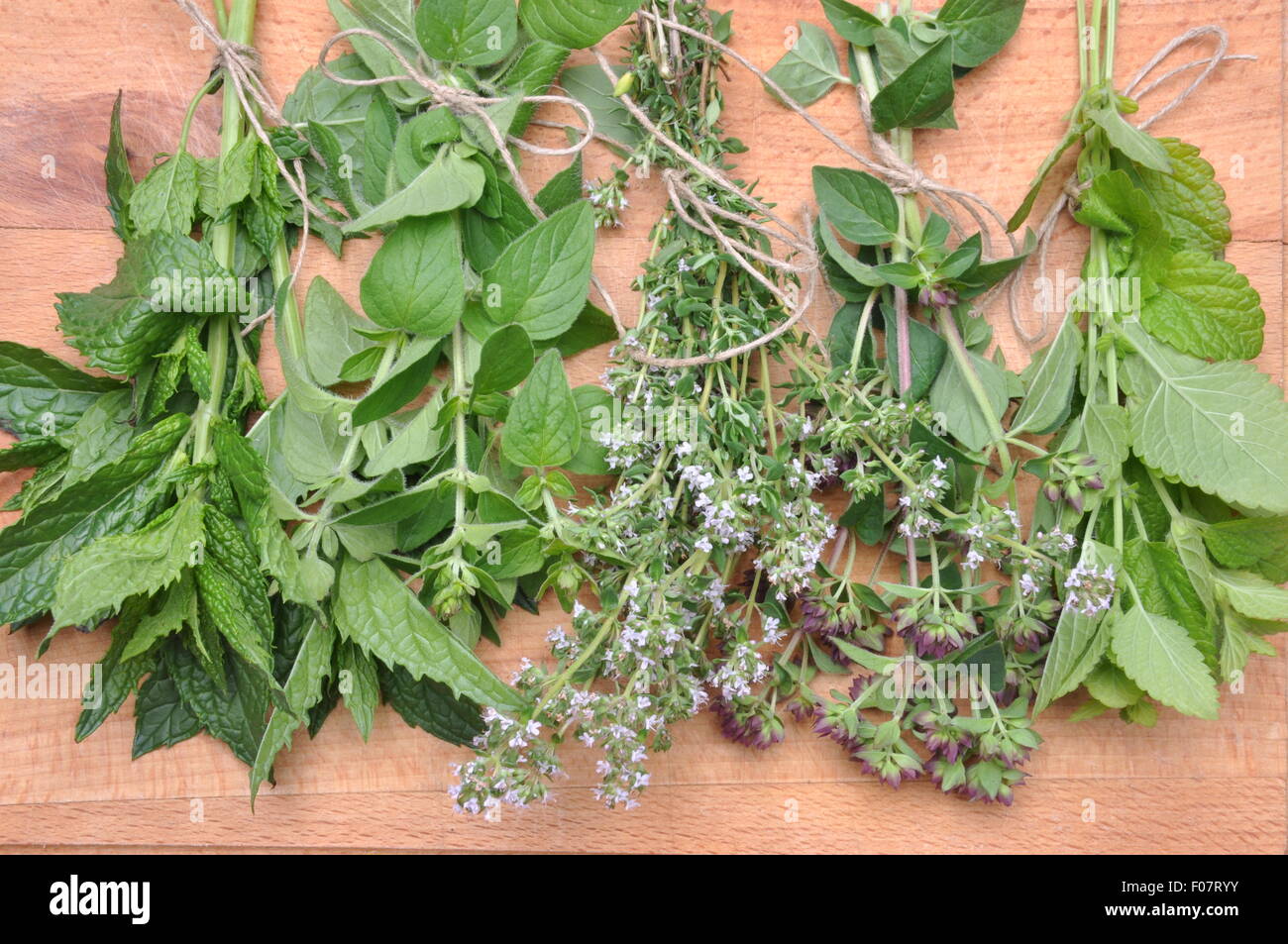 Fresh green herbs on old wooden table Stock Photo - Alamy