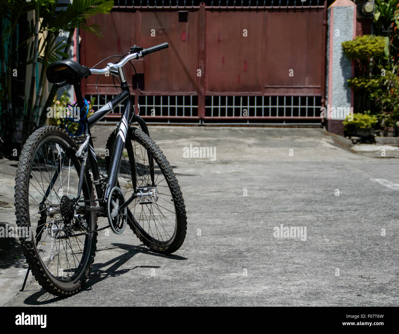 A bicycle parked beside the house in a certain subdivision Stock Photo ...