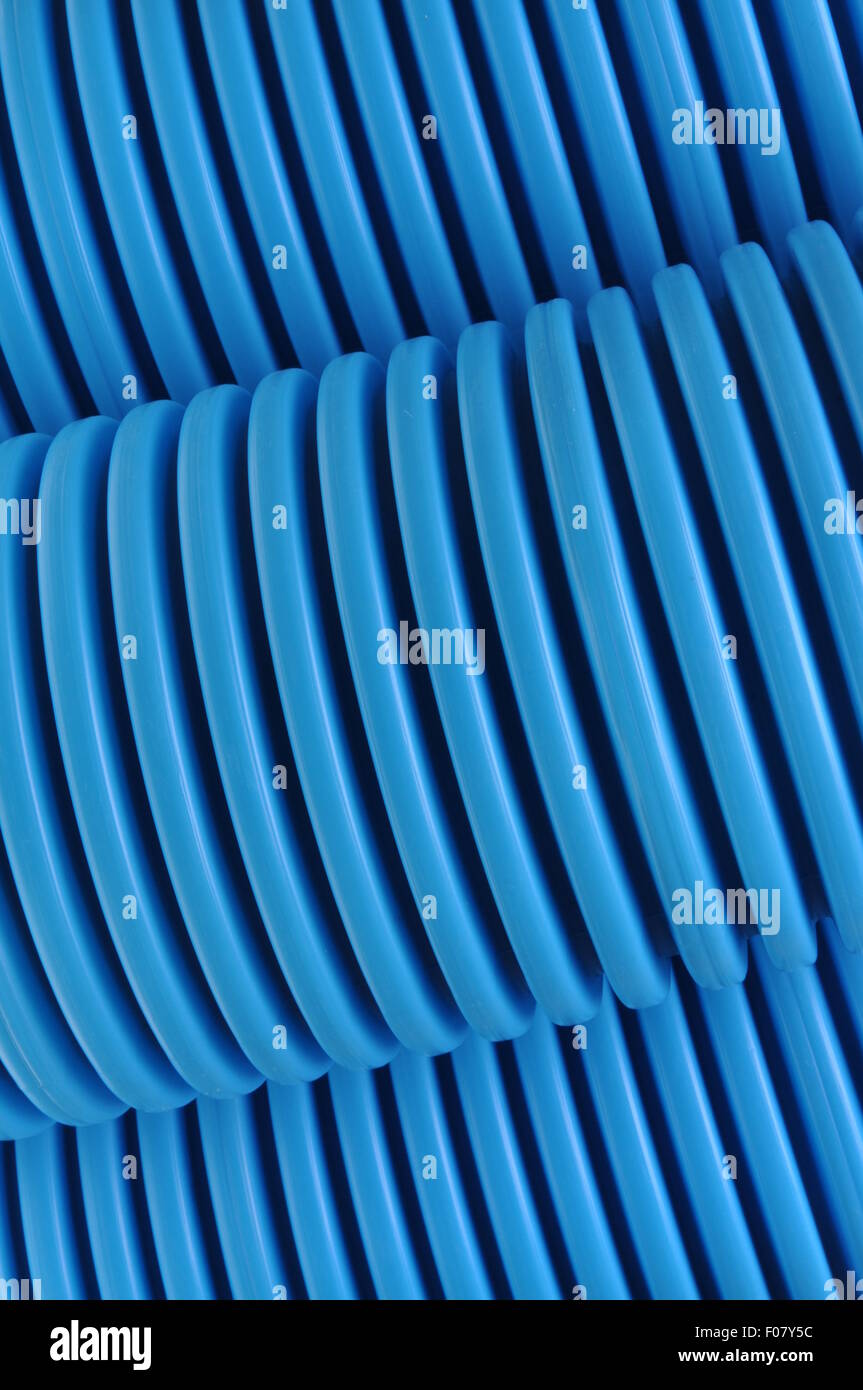 Blue curvilinear tubes for industry Stock Photo - Alamy