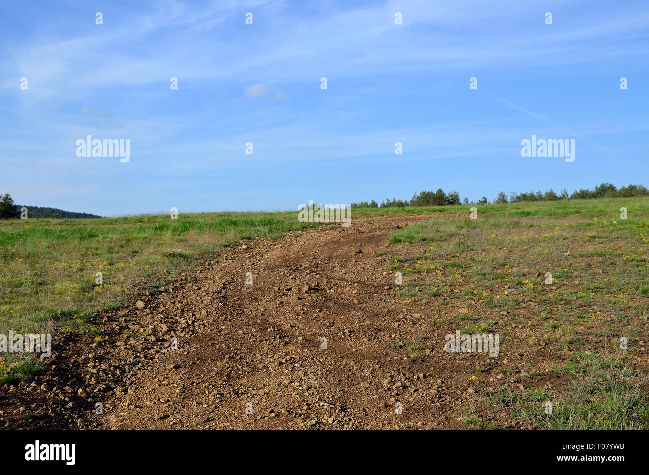 Ground path through green mountain fields in spring time Stock Photo ...