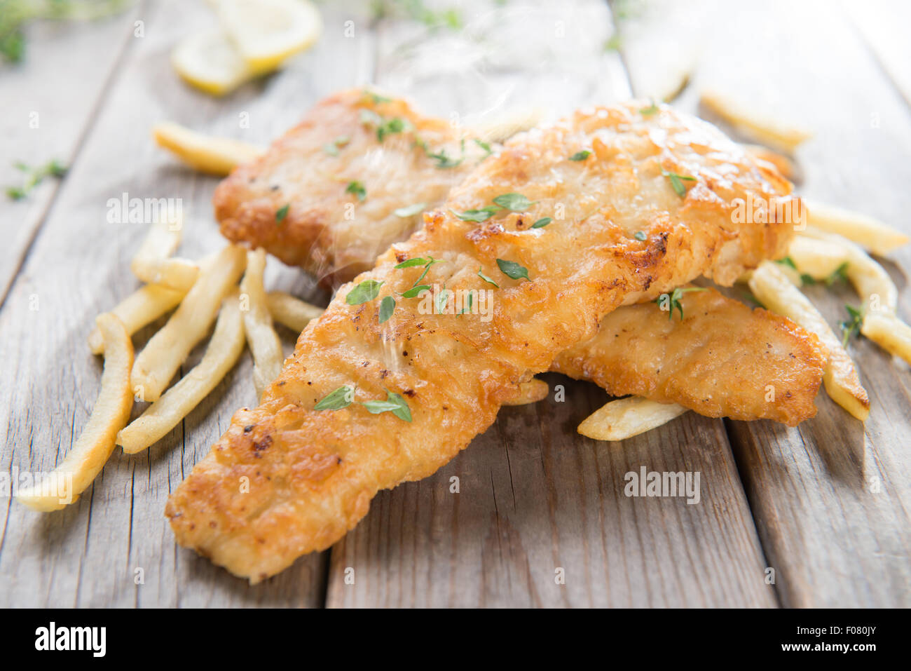 Fish and chips. Fried fish fillet with french fries on old wooden ...